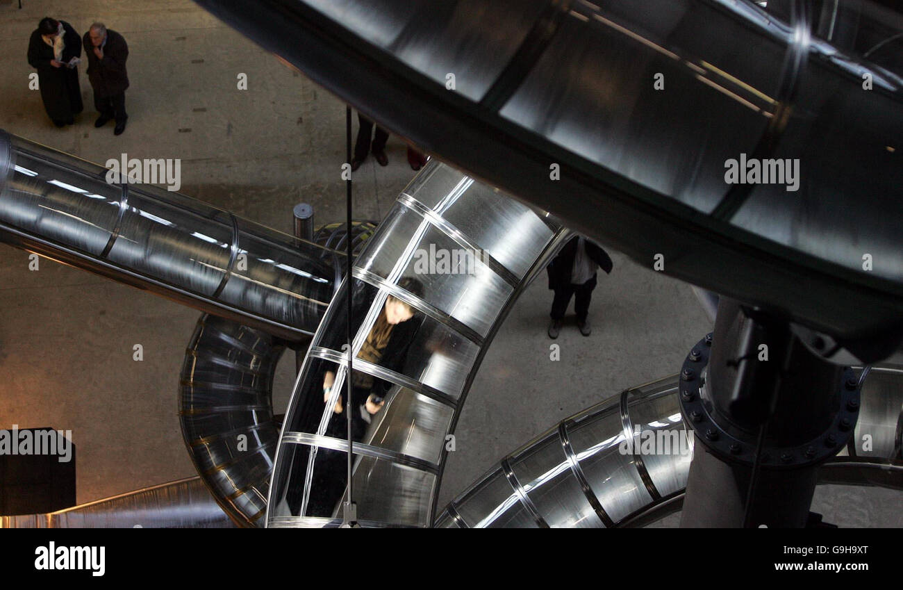 A visitor to the Tate Modern in London rides on one of the, newly ...