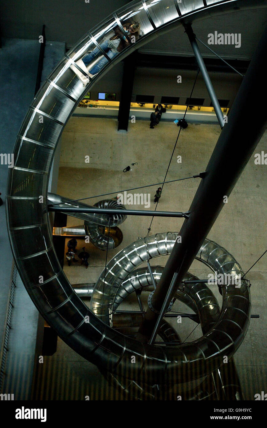 A visitor to the Tate Modern in London rides on one of the, newly ...
