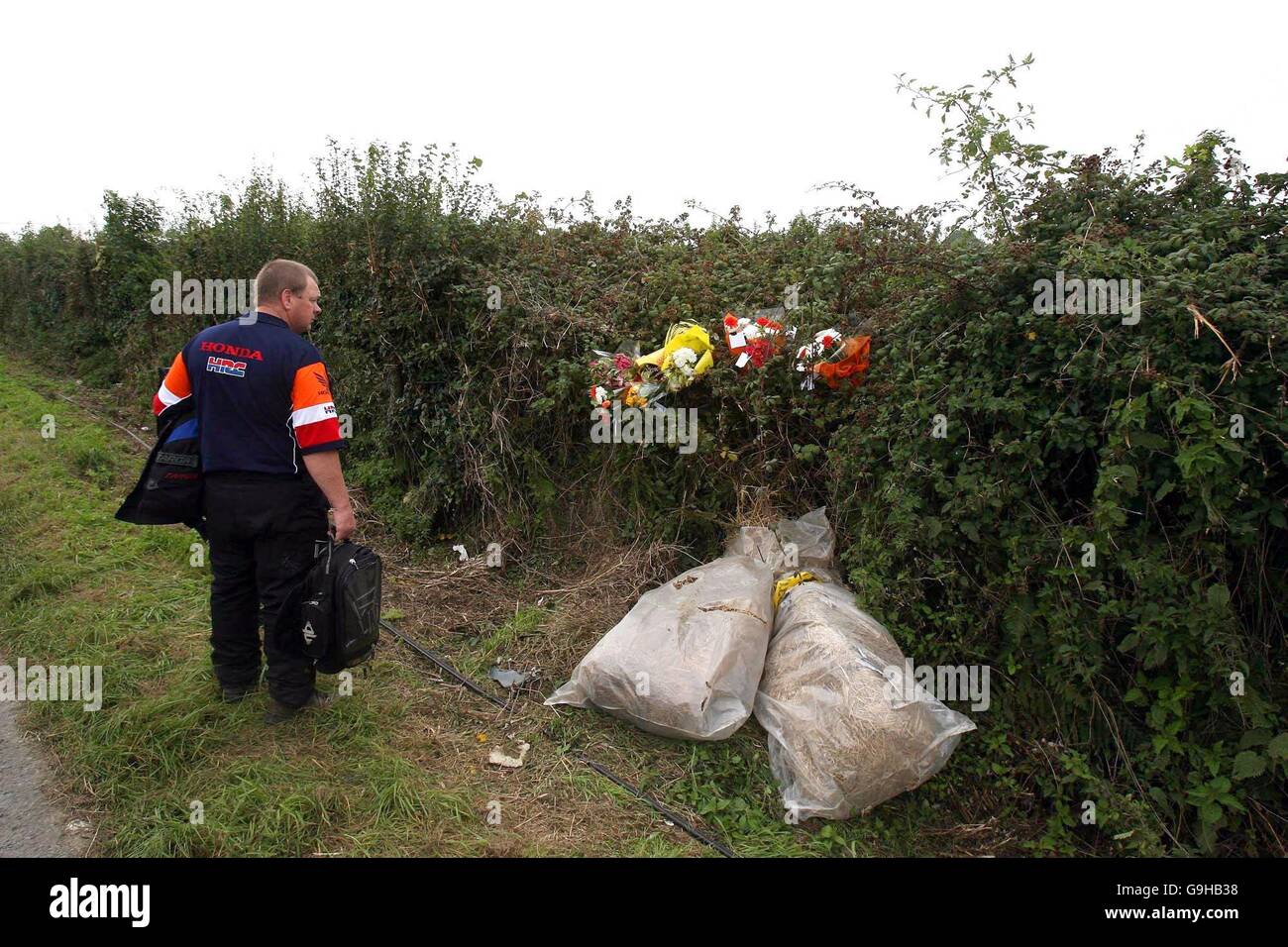 A motorcycle fan read tributes left at the spot where Northern Irish ...