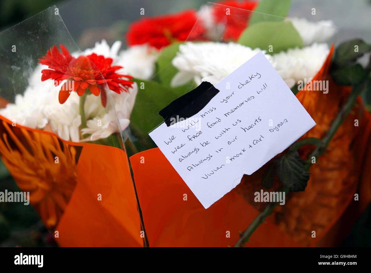 Floral tributes are left at the spot where Northern Irish cyclist ...