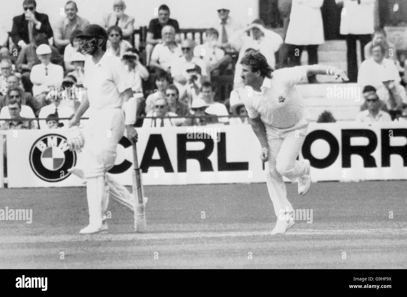 Worcestershire's Ian Botham (r) delivers his first over in his debut ...