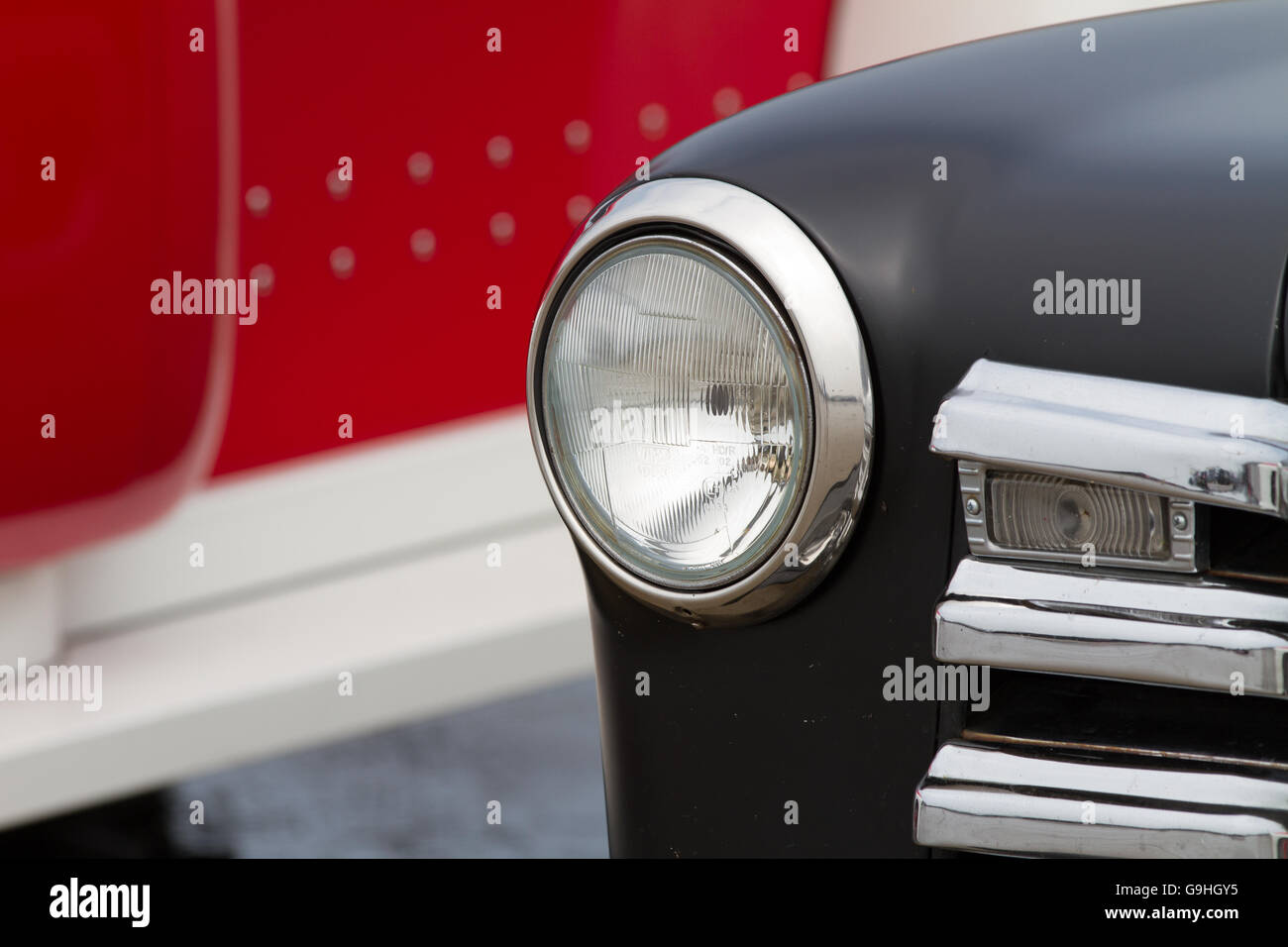 Part of a classic American car at a vintage rally. Showing a round ...