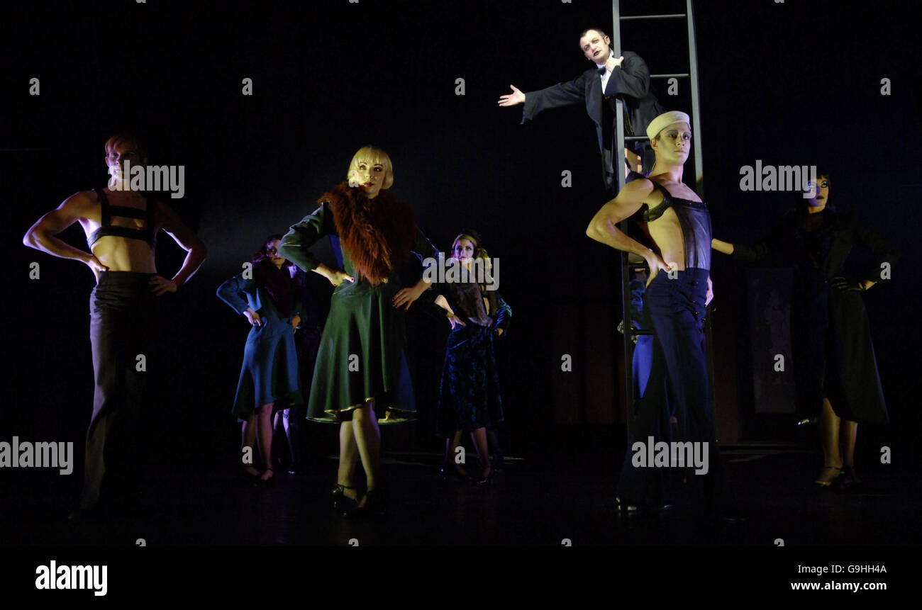 The cast (including James Dreyfus as Emcee, background) during a ...