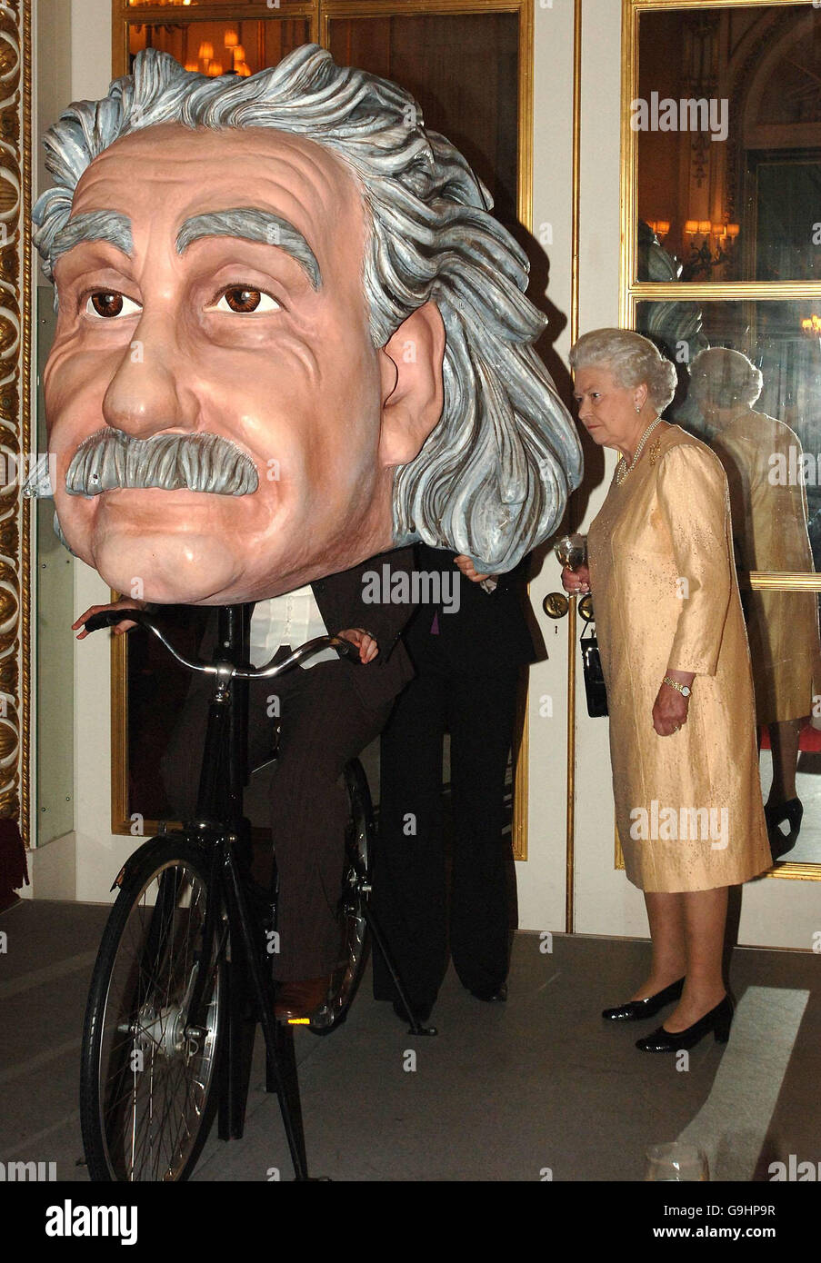 Britain's Queen Elizabeth II looks into the head of Albert Einstein ...