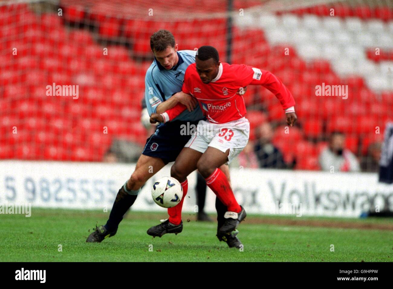 Nottingham Forest's David Johnson holds off the challenge of Boltons ...