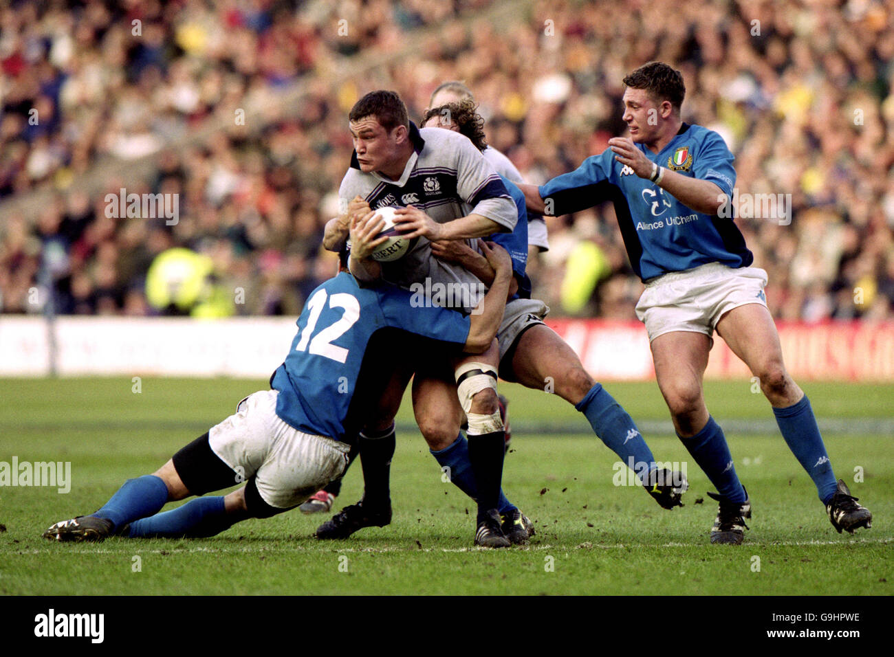 Scotland's Gordon Bulloch (c) fights to keep possession against Italy ...