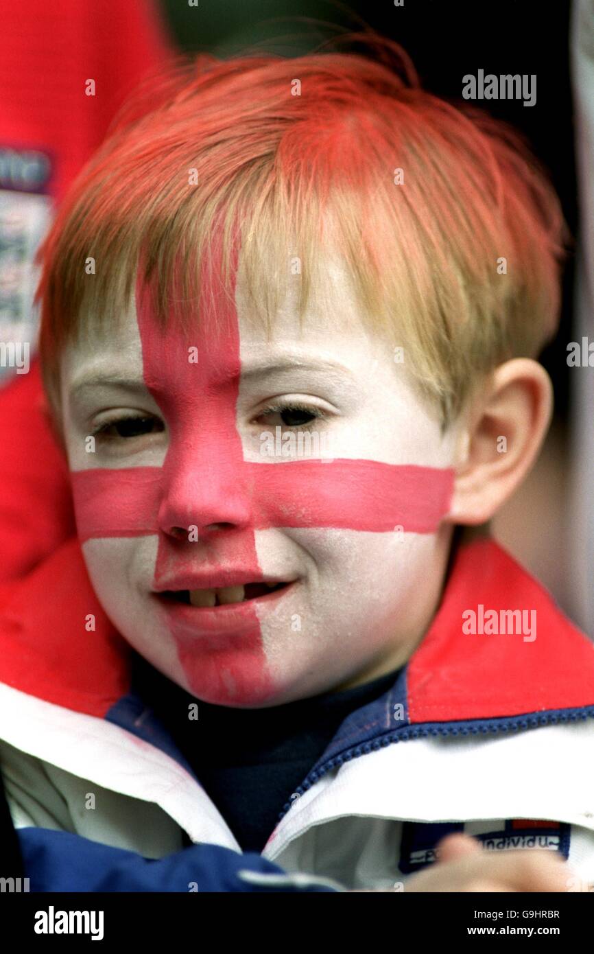 An England fan with the flag of St George painted on his face Stock ...