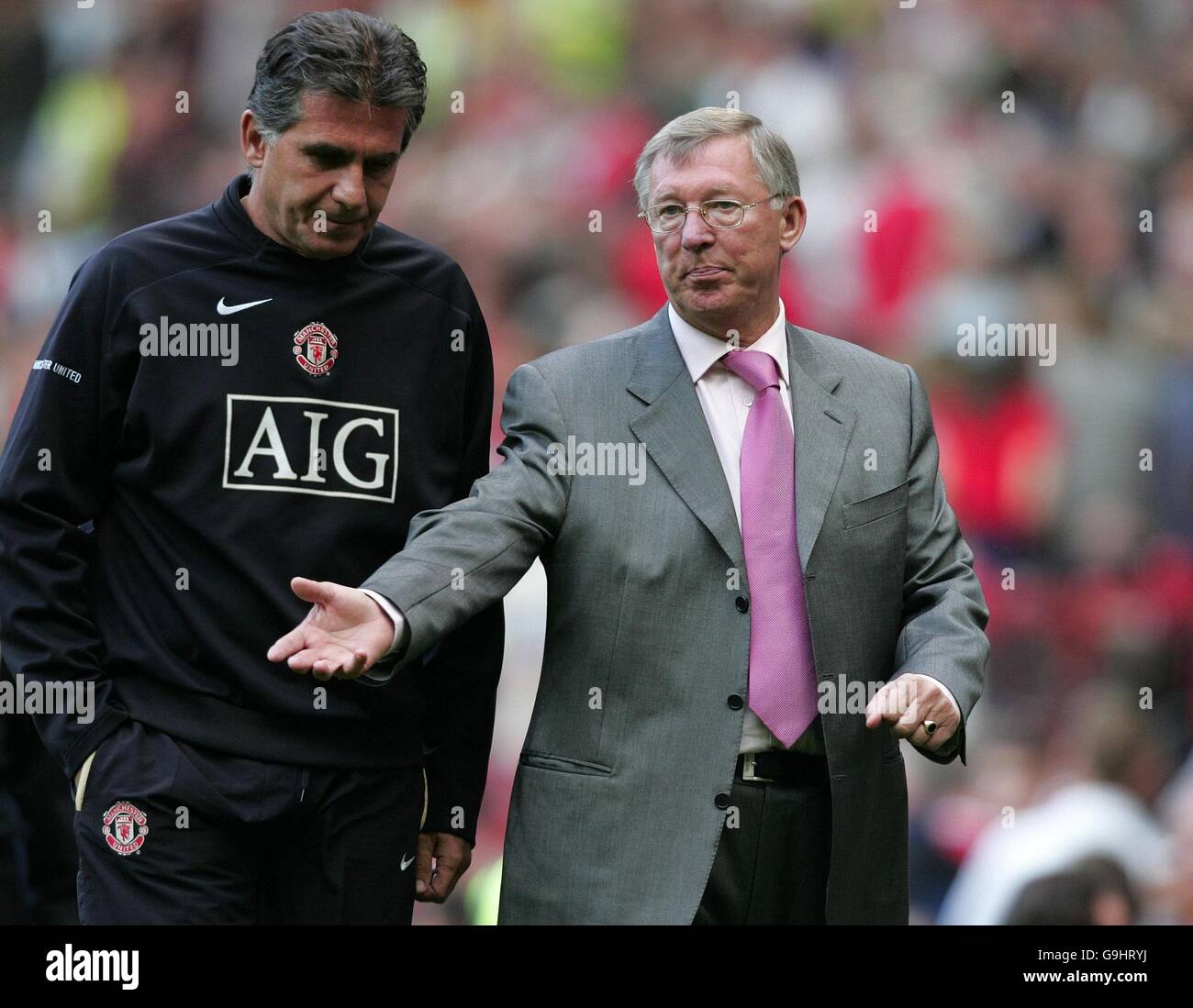 Manchester United manager Sir Alex Ferguson speaks to his assistant ...