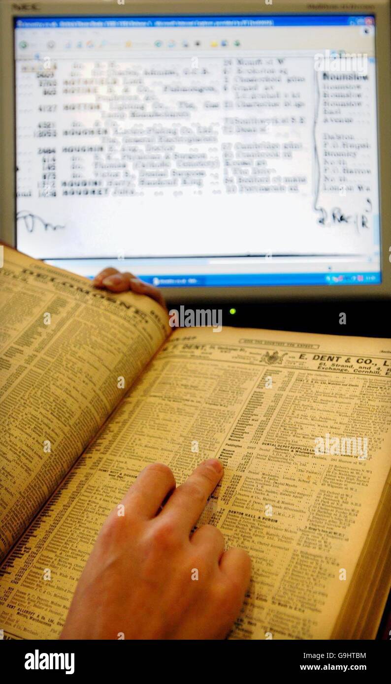 A british telecom employee looks 1920 london telephone directory hi-res ...