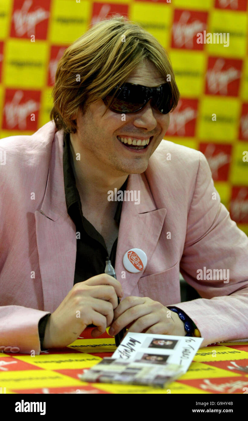 Nicky Wire, bass player from the Manic Street Preachers, signs copies ...