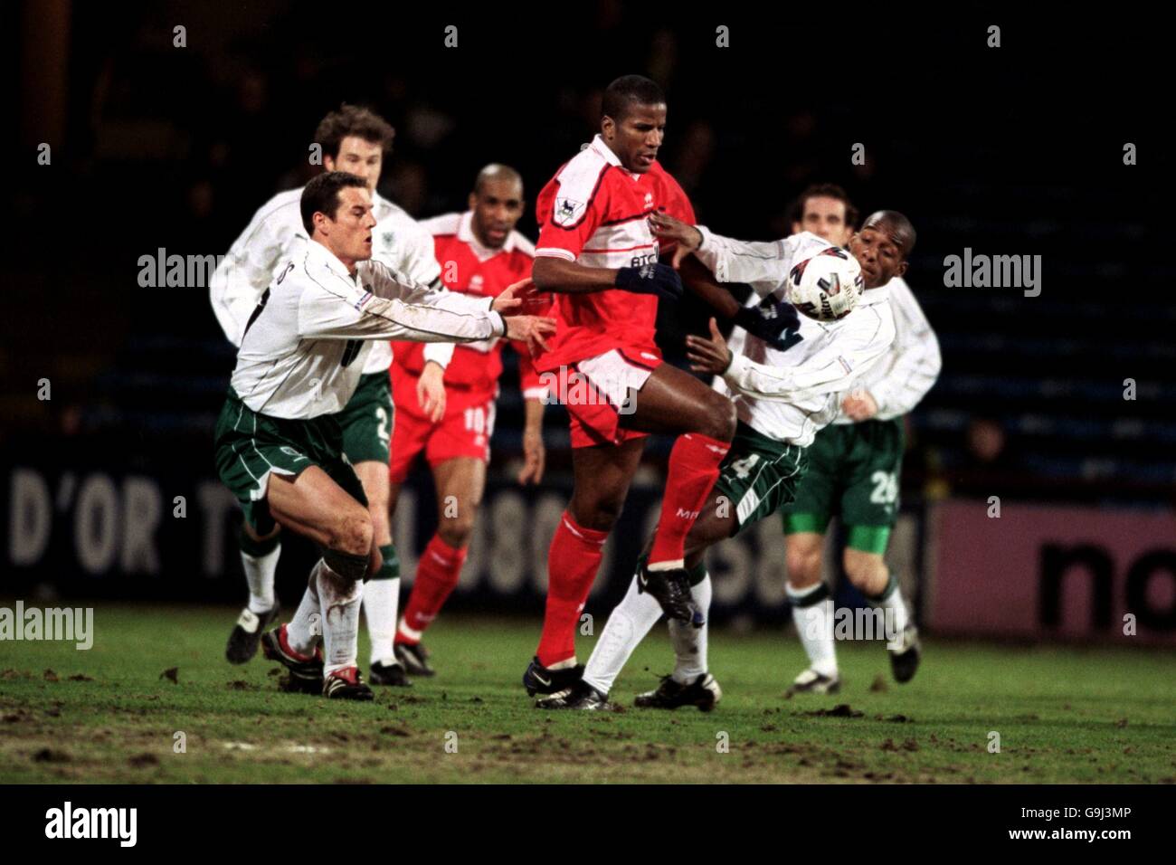 Middlesbrough's Brian Deane (c) holds off the challenge's of Wimbledon ...