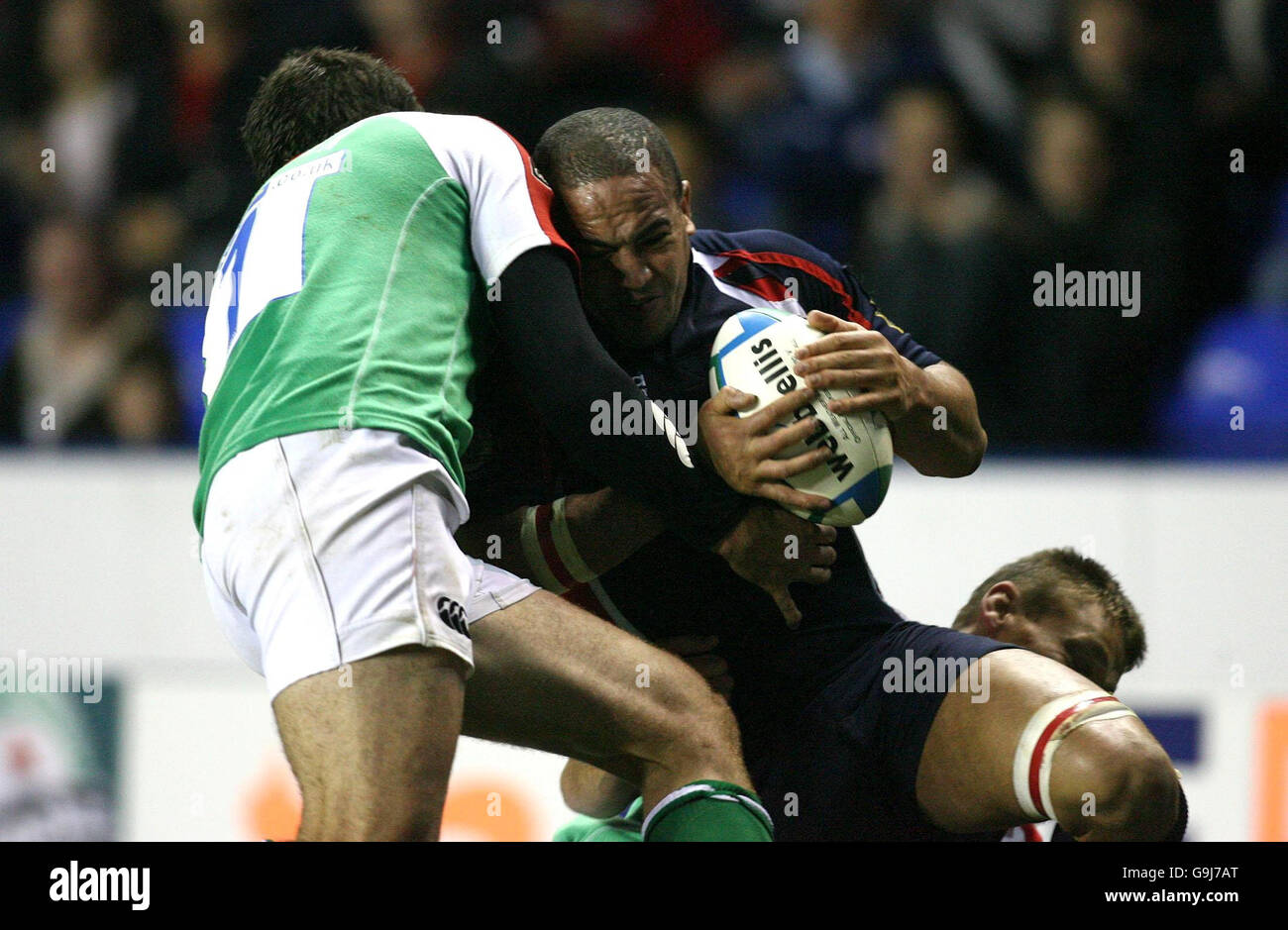 Llanelli's Gavin Thomas tries to force his way over the try line ...