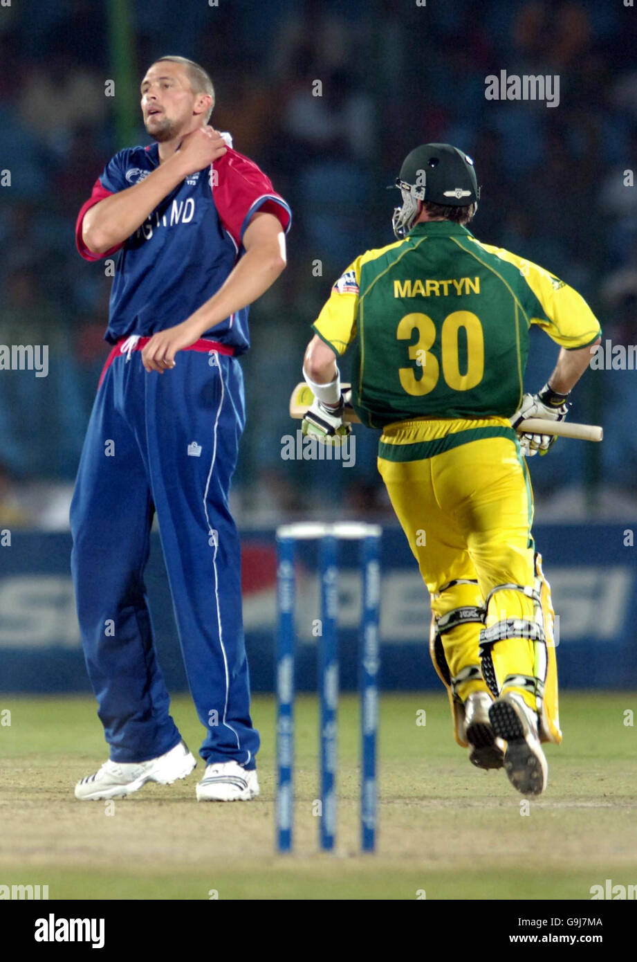 Australia's Damien Martyn (right) runs past England's Steve Harmison ...