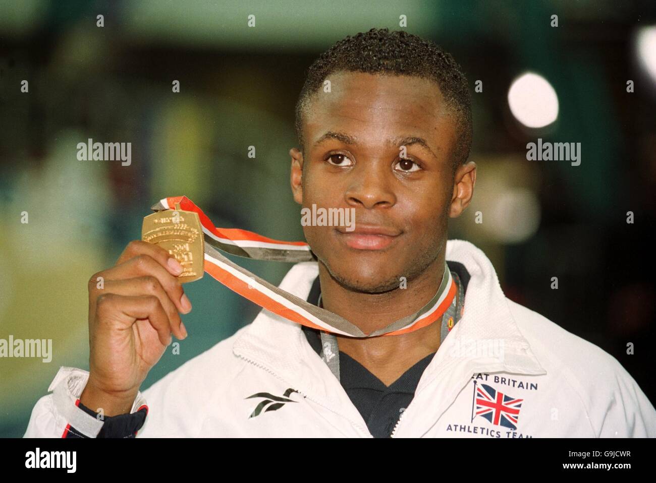 Great Britain's Daniel Caines holds up his gold medal in celebration ...