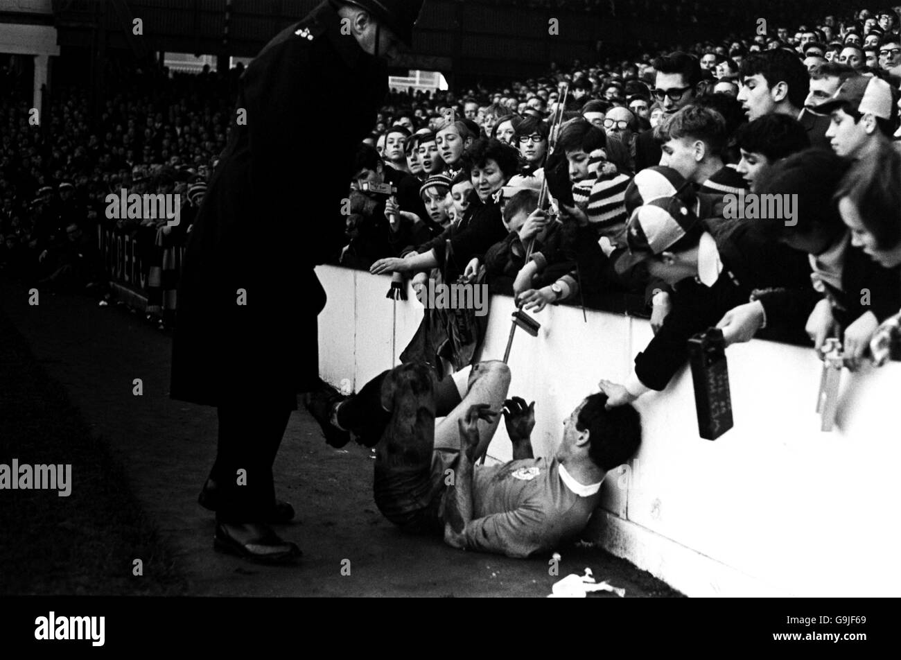 Leicester City's Derek Dougan receives a pat on the head from a young ...