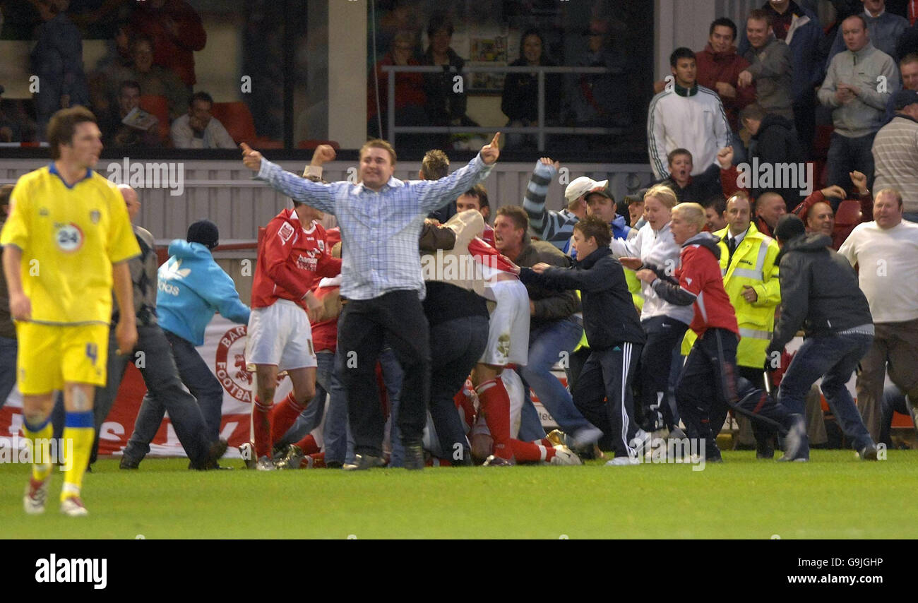Barnsley fans invade the pitch to celebrate their third goal with the ...
