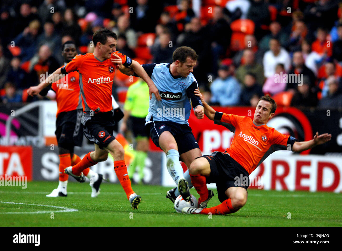 Dundee United's Mark Kerr and Greg Cameron battle with Rangers' Charlie ...