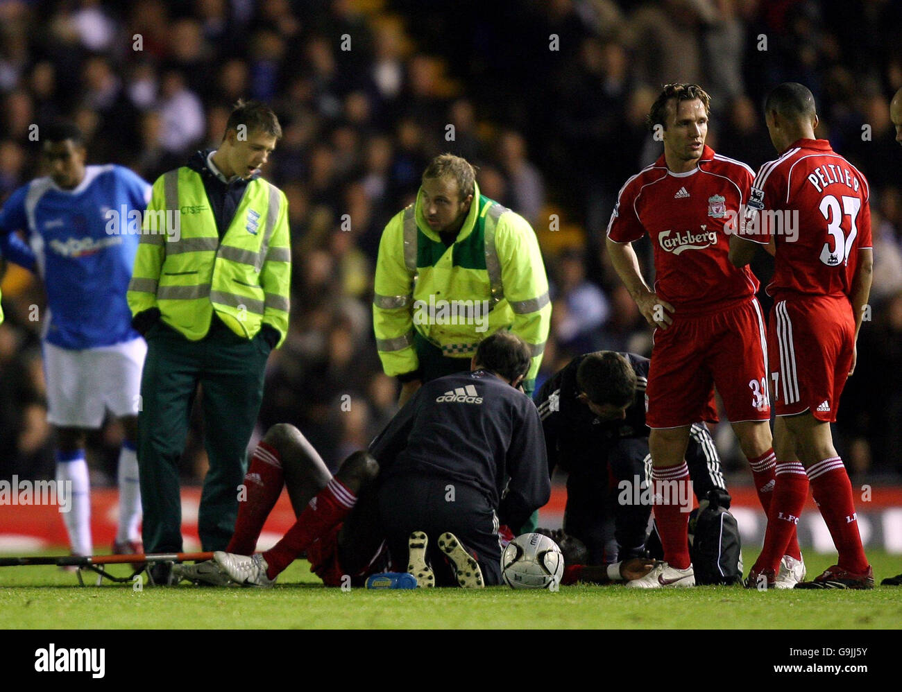 Liverpool's Mohamed Sissoko receives treatment after suffering a ...