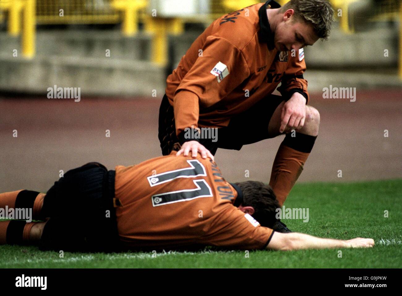Wolverhampton Wanderers' Adam Proudlock checks on team mate Andy Sinton ...