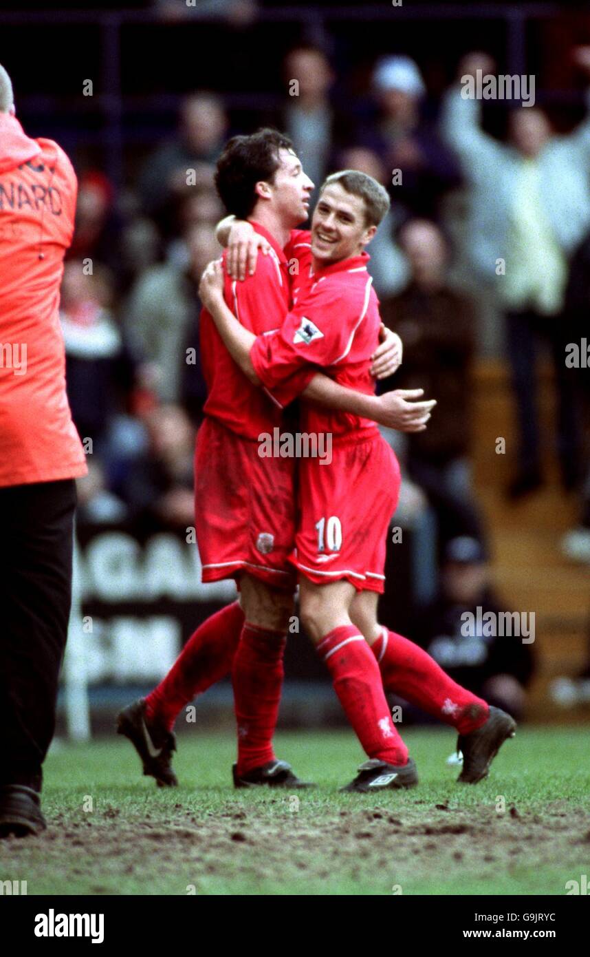 Liverpool's Robbie Fowler (l) celebrates scoring the fourth goal with ...