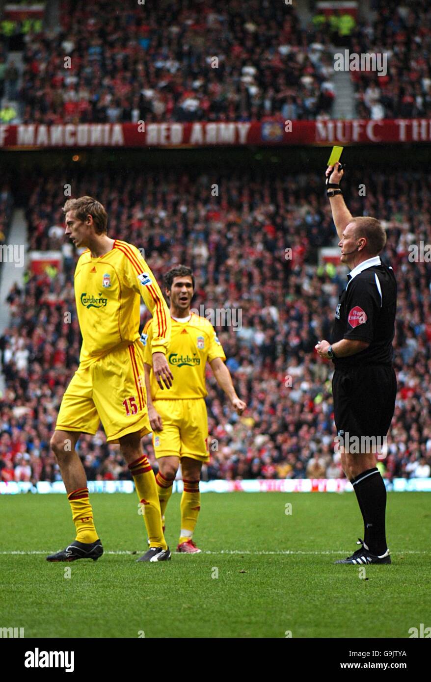 Referee Graham Poll (r) shows Liverpool's Peter Crouch the yellow card ...