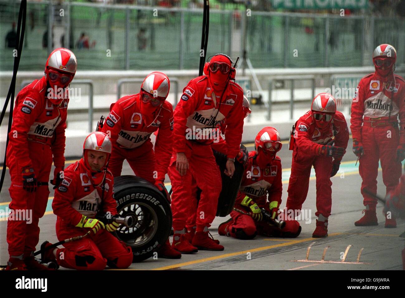 The ferrari pit crew await michael schumacher hi-res stock photography ...