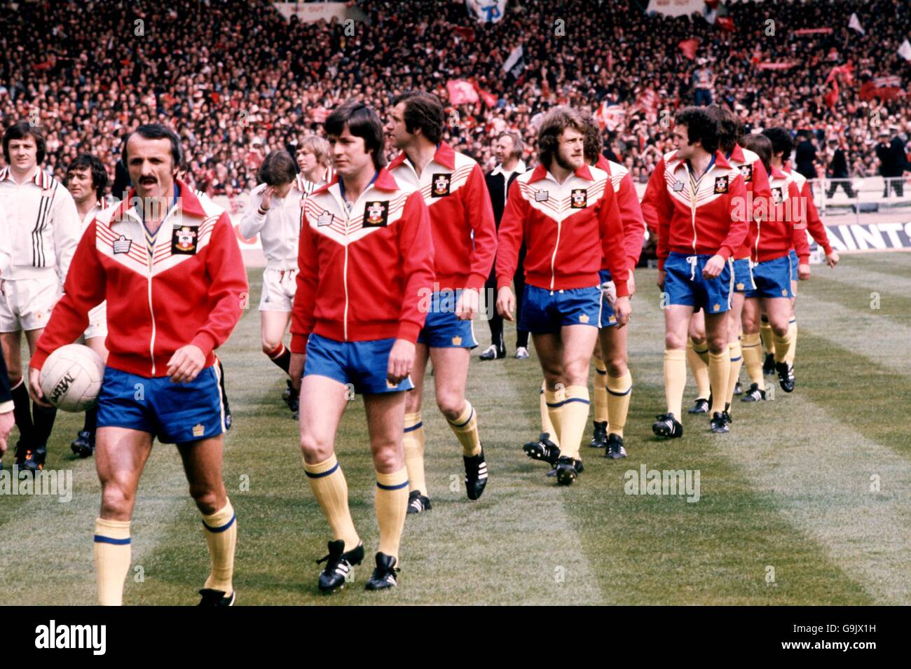 (L-R) Southampton captain Peter Rodrigues leads his team out at Wembley ...