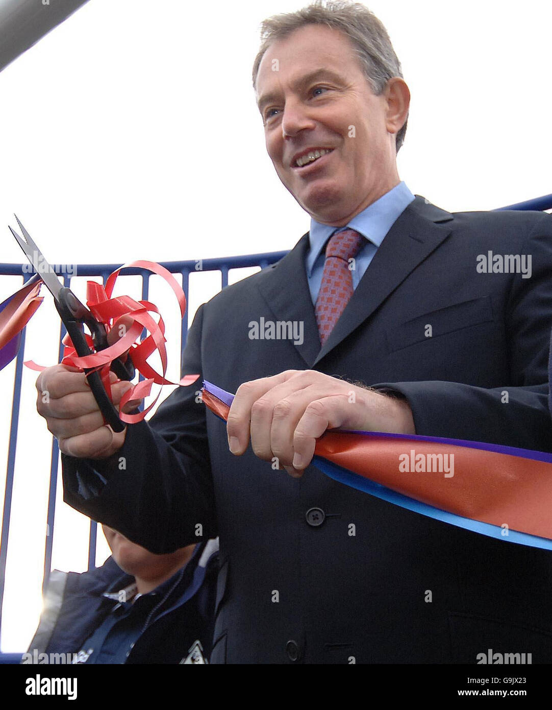 Britain's Prime Minister Tony Blair cuts the ribbon as he opens a ...