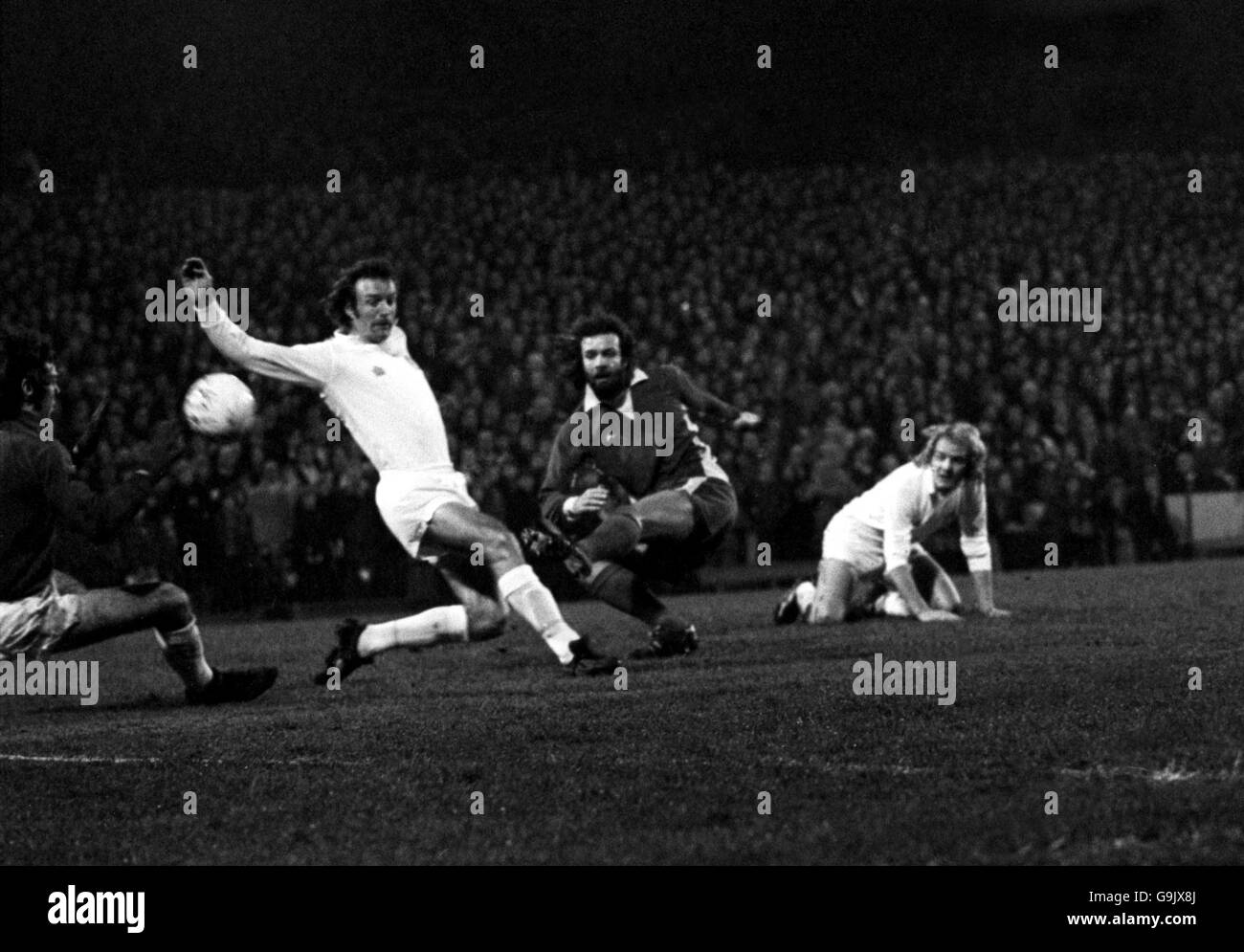 Wimbledon's Roger Connell (second r) fires in a shot at Leeds United ...