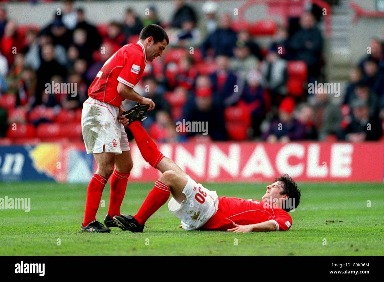 Nottingham Forest's Francis Benali (l) helps teammate Keith Foy (r ...