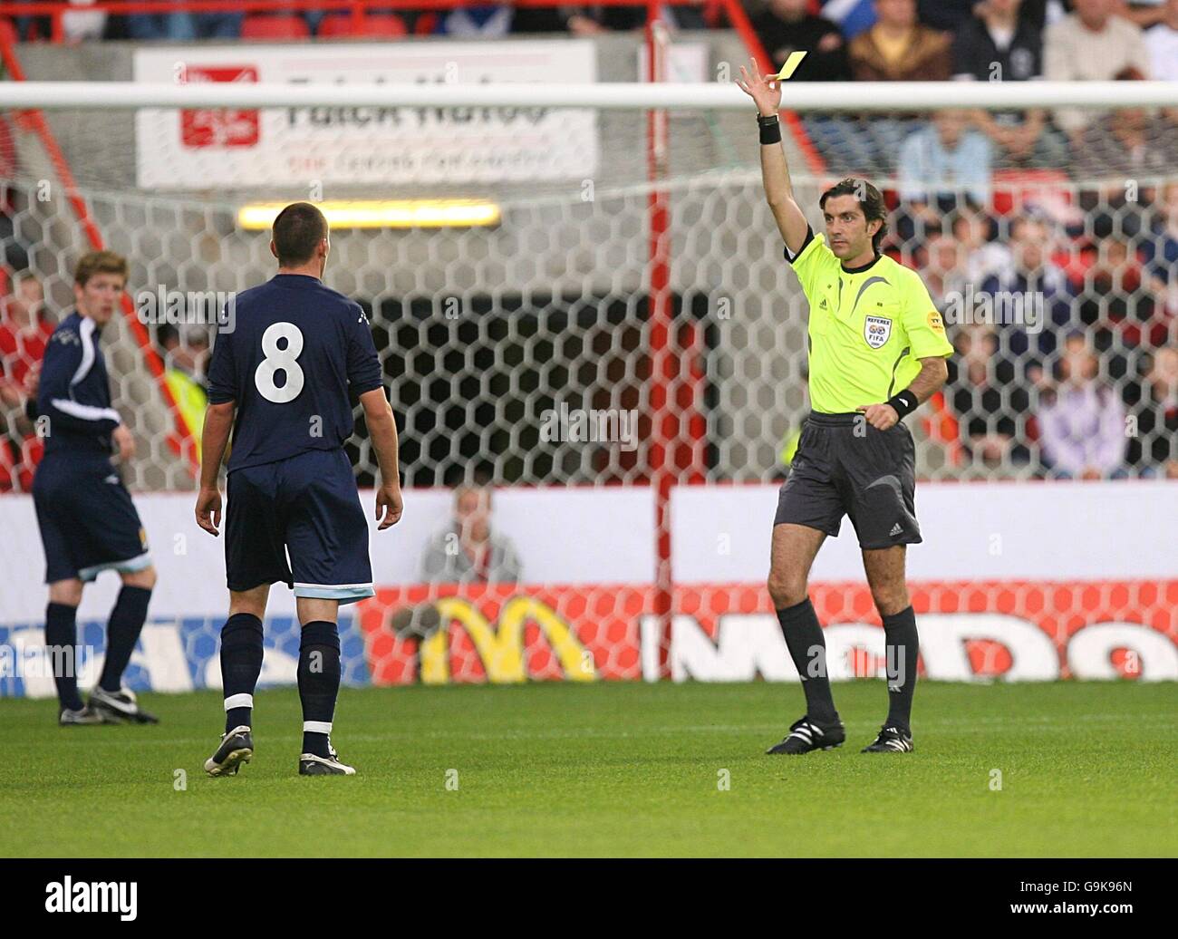 Scotland's Scott Brown receives a yellow card from referee Tiziano ...