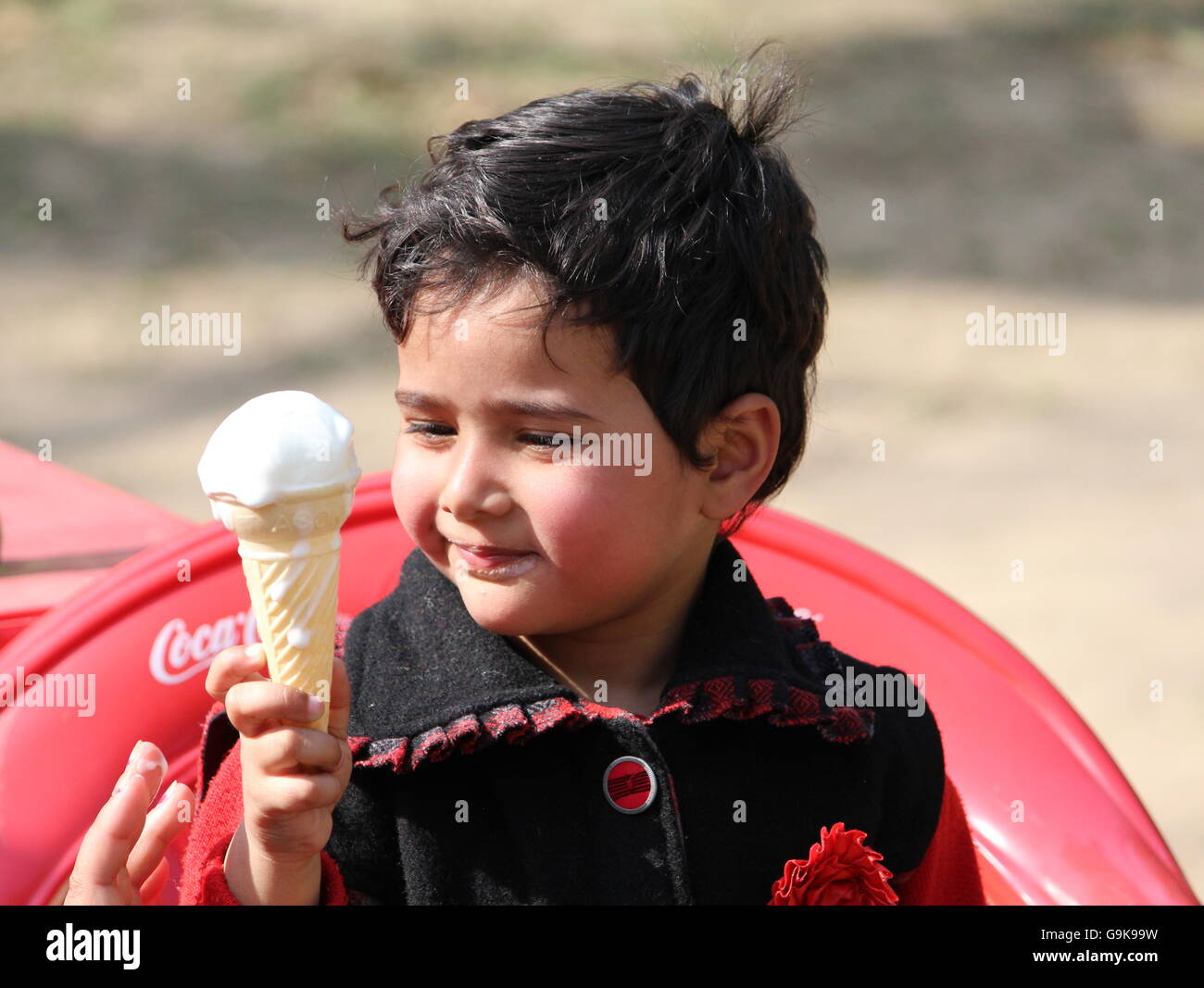 Little Kid enjoying Ice cream in sunny winter Stock Photo - Alamy
