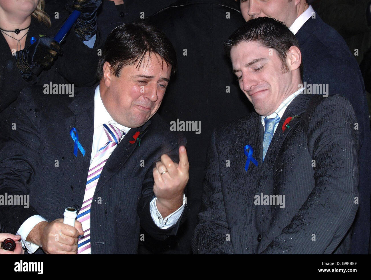 Half length speaking gesturing smiling pointing champagne celebration ...