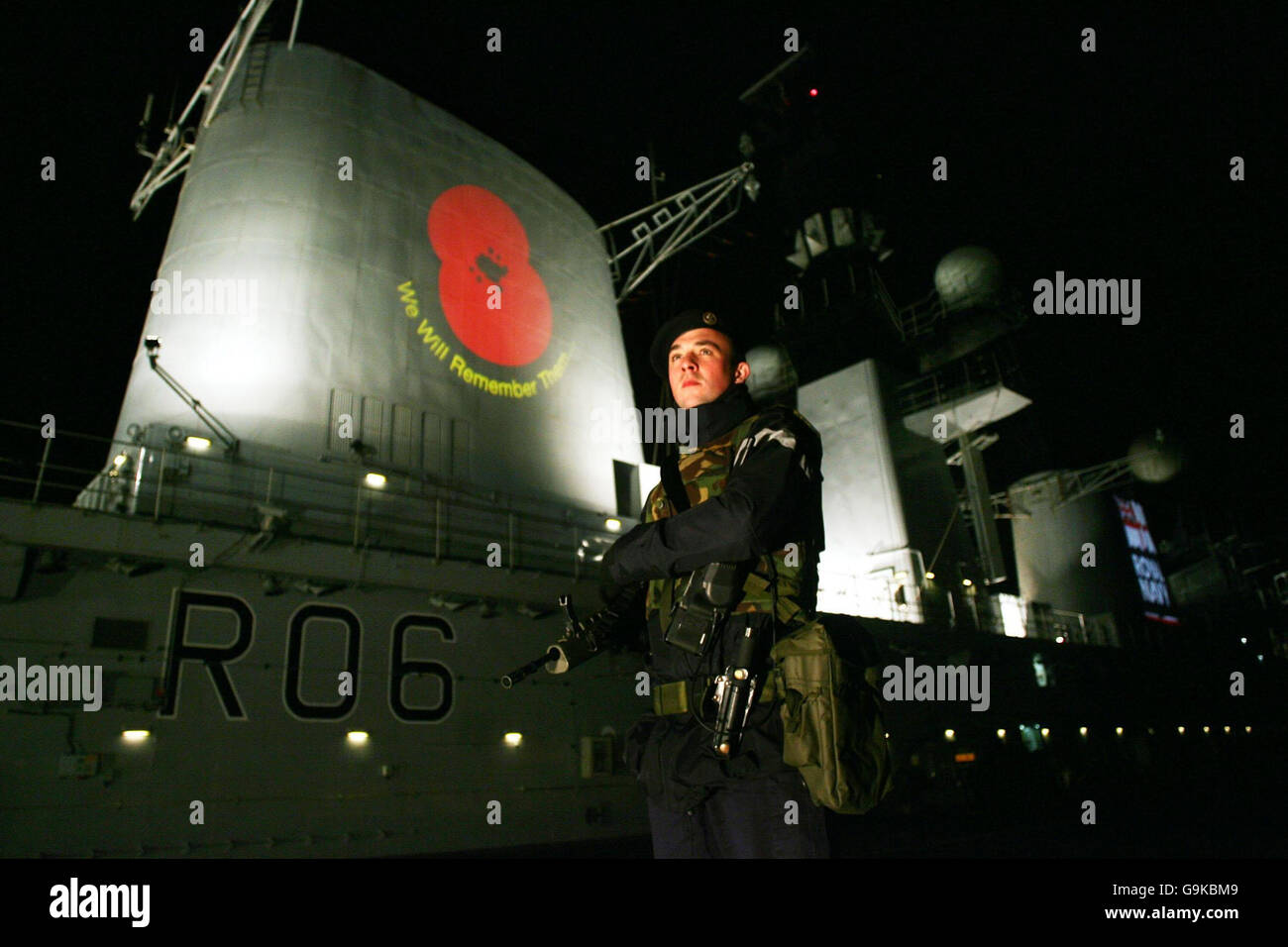 ONC David Lansley stands aboard HMS Illustrious, as a poppy is ...