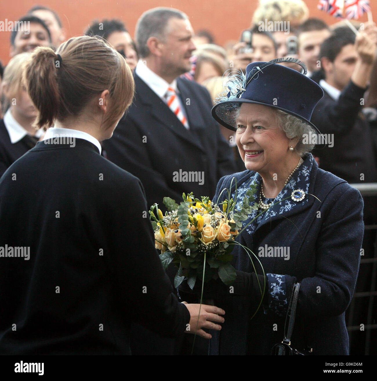Britain's Queen Elizabeth II receives a bouquet from Emilly Travis as ...