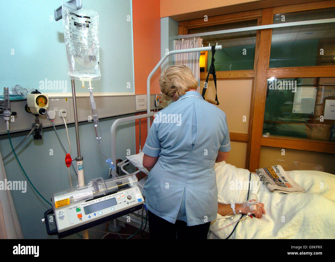 A nurse treats a patient in a ward at the Royal Orthopaedic Hospital ...