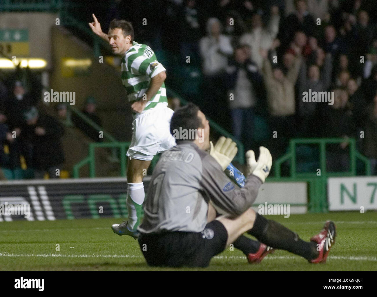 Maciej Zurawski (behind) turns away after scoring for Celtic as ...