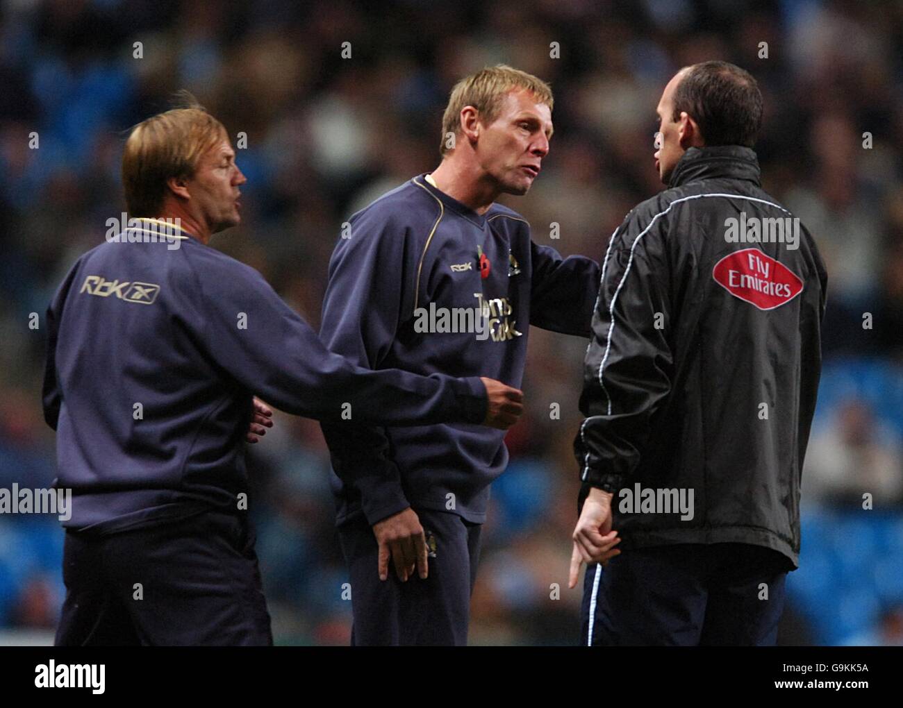 Manchester City coach Steve Wigley restrains manager Stuart Pearce as ...