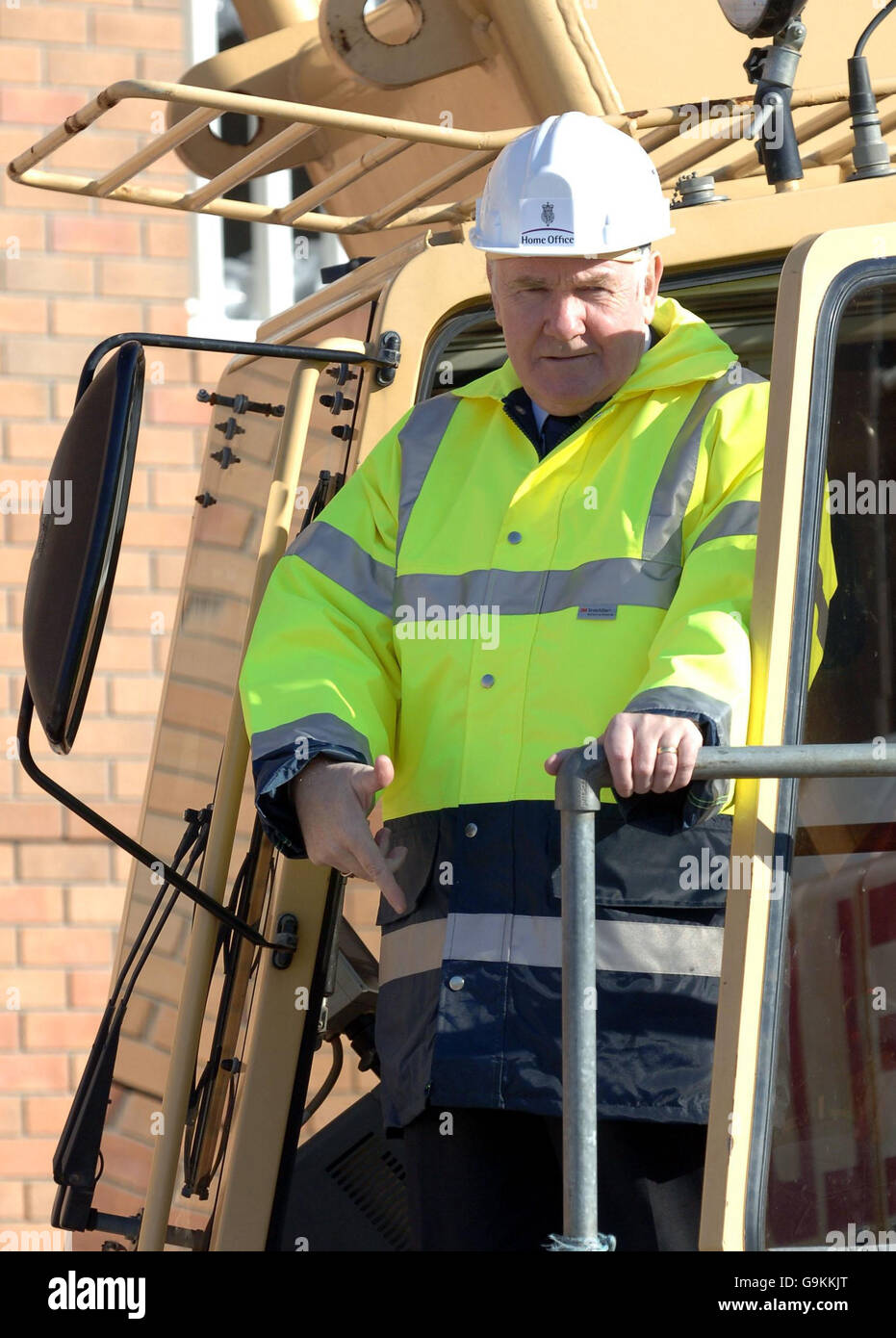 John Reid help workers build new prison cells at High Down Prison Stock ...