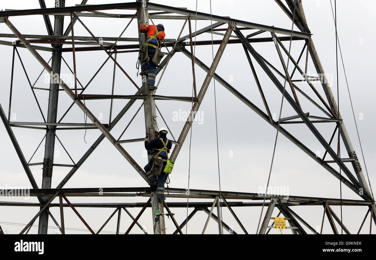 Linesman Erectors climb the electricity pylon to carry out the ...