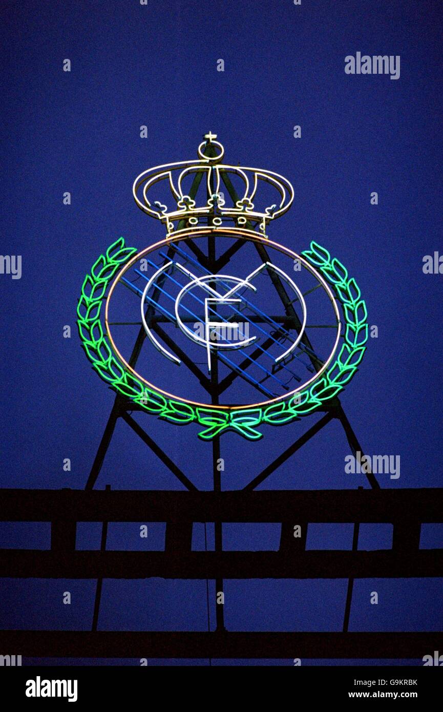 The neon real madrid badge glows against the night sky hi-res stock ...