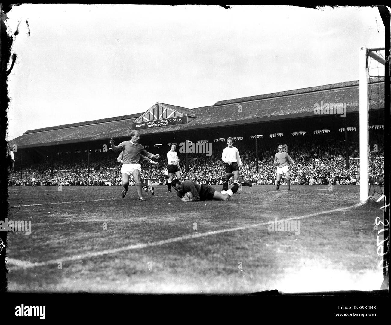 Fulham goalkeeper Tony Macedo (on floor) saves at the feet of ...
