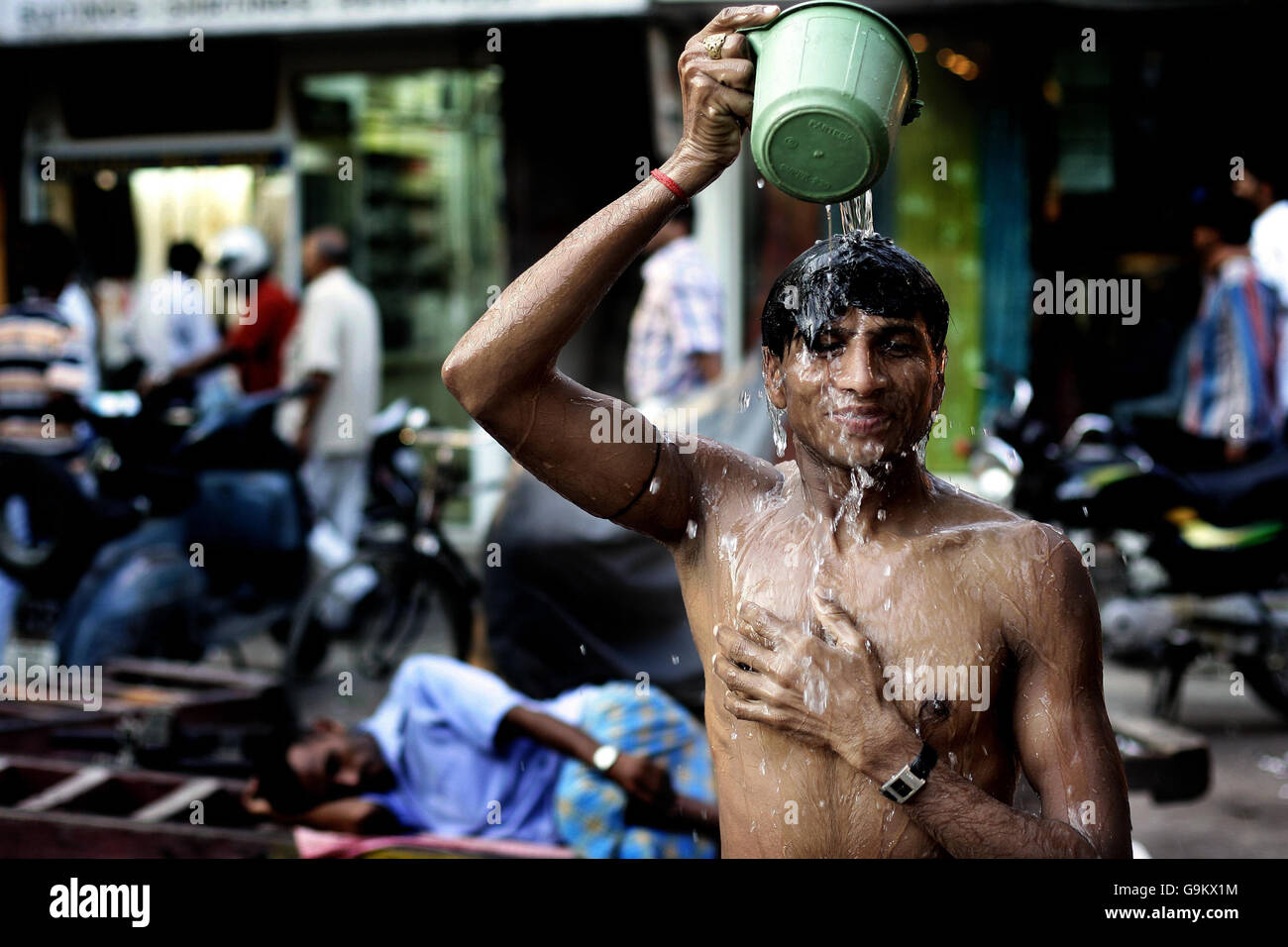 File picture of a young man having a wash in the streets of Old Delhi ...