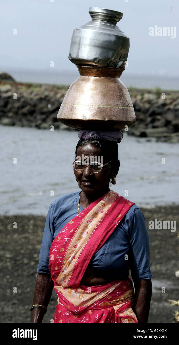 File picture of a lady carrying a pot on her head in Mumbai, India ...