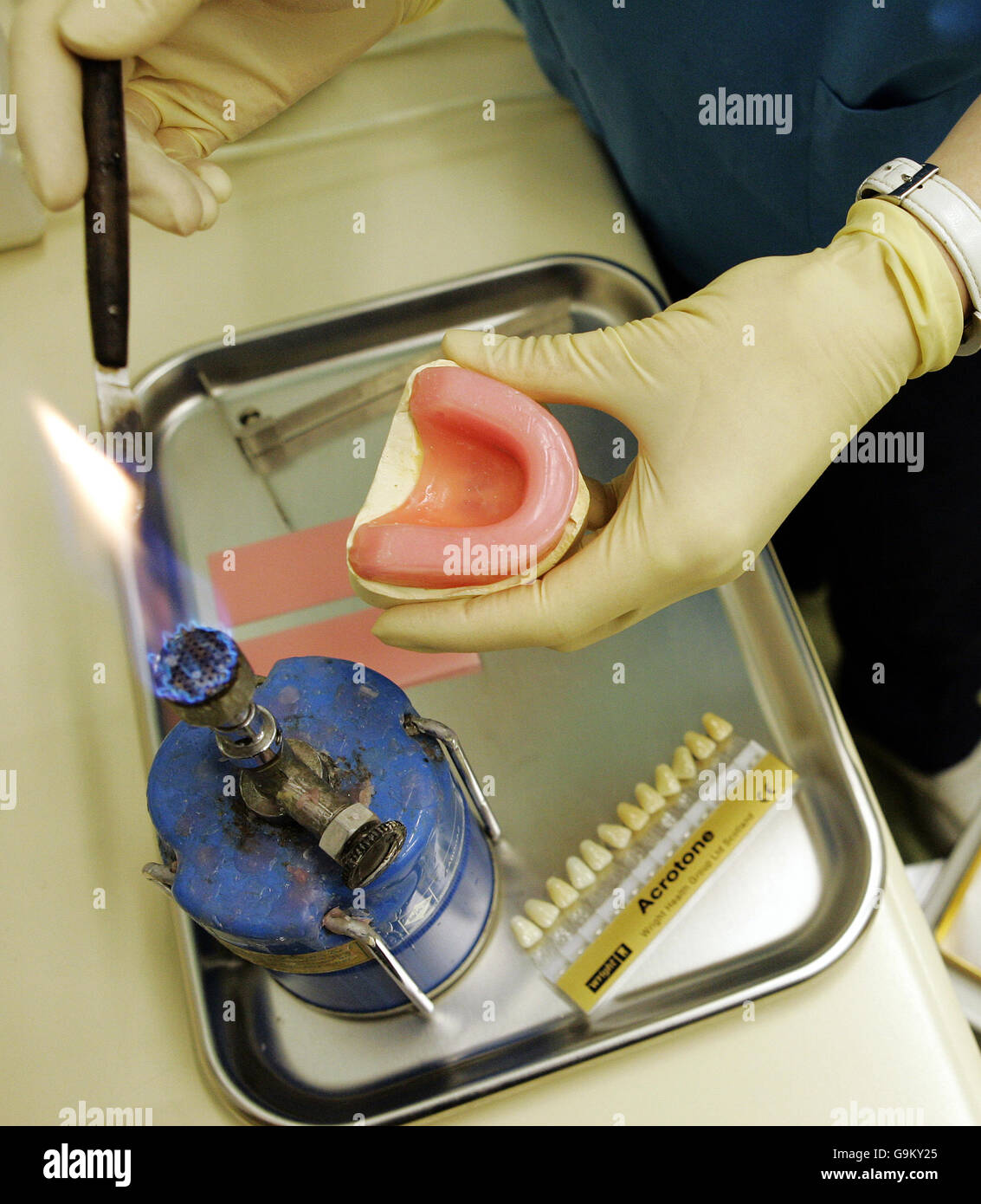 A dental nurse holds prepares the mold for making false teeth Stock ...
