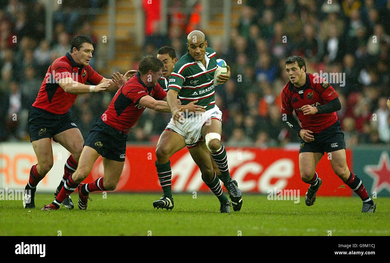 Leicester's Tom Varndell tries to break through a tackle by Munster's ...