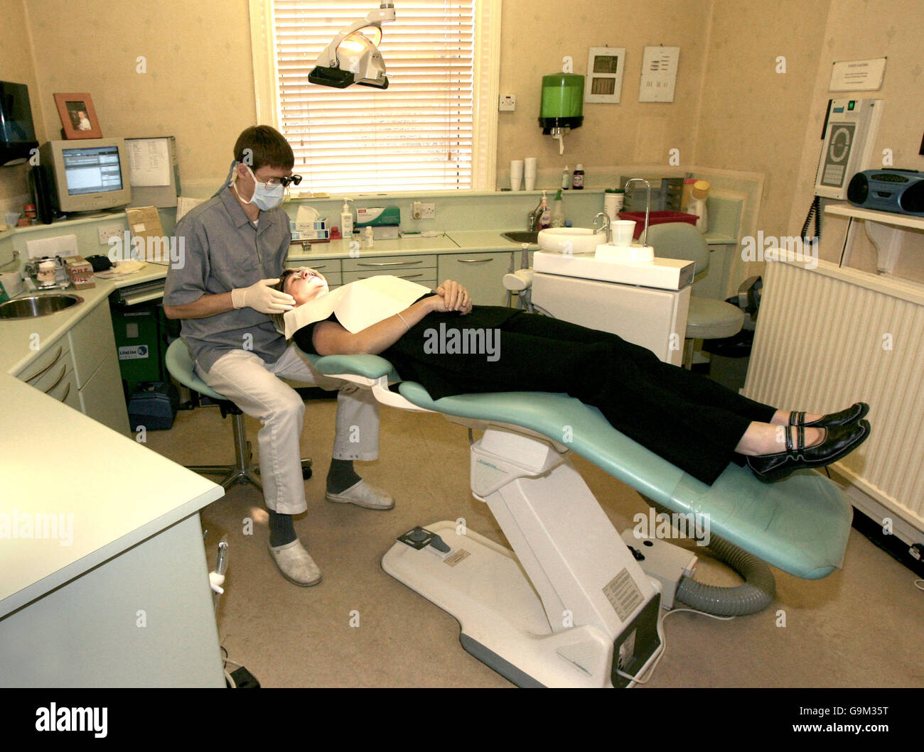 Private Dentist Doctor Gregory Foster performs a routine check-up at ...