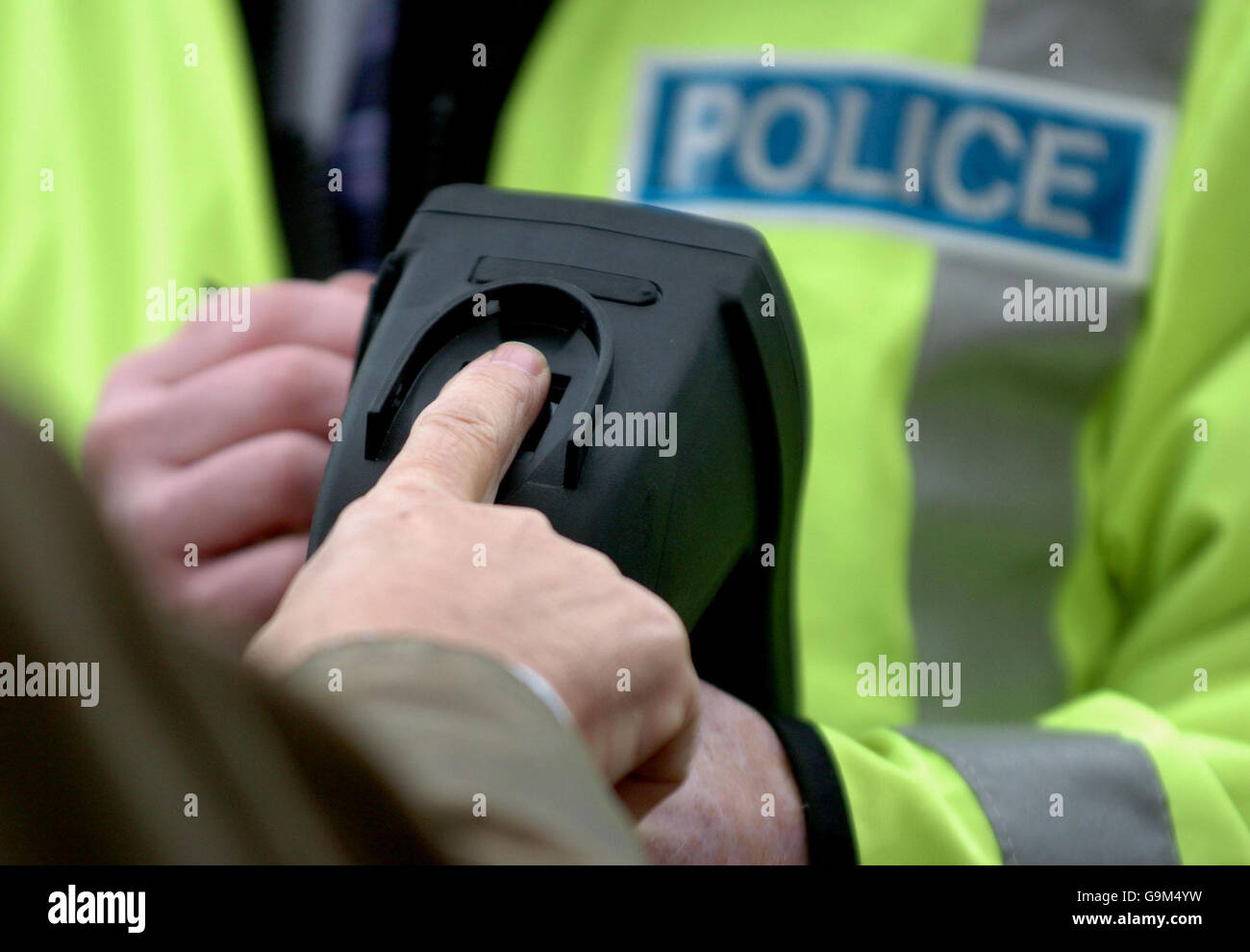Hand-held fingerprint reader - trial begins Stock Photo - Alamy