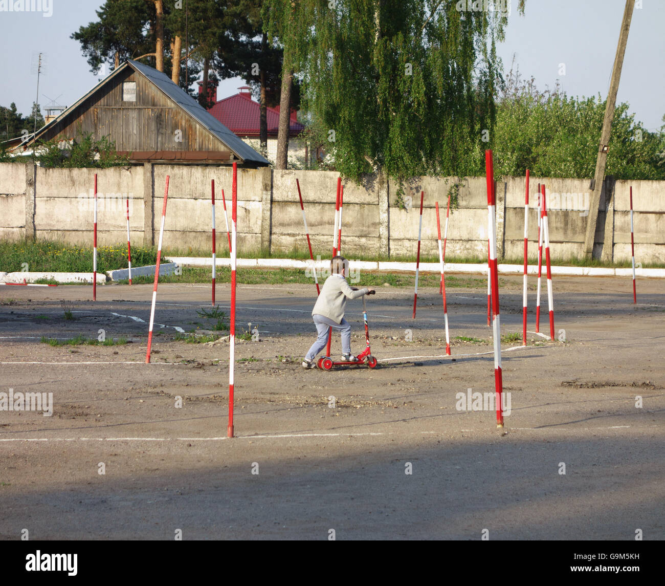 boy learning to ride a scooter at the driving school site Stock Photo ...