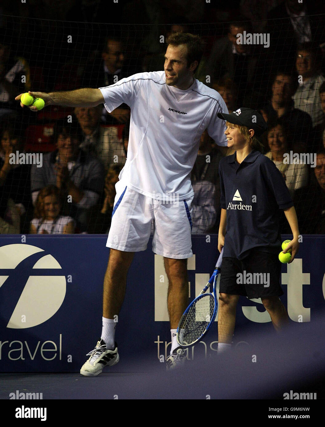 England's Greg Rusedski gives 12-year-old ball boy Colin Mathieson the ...